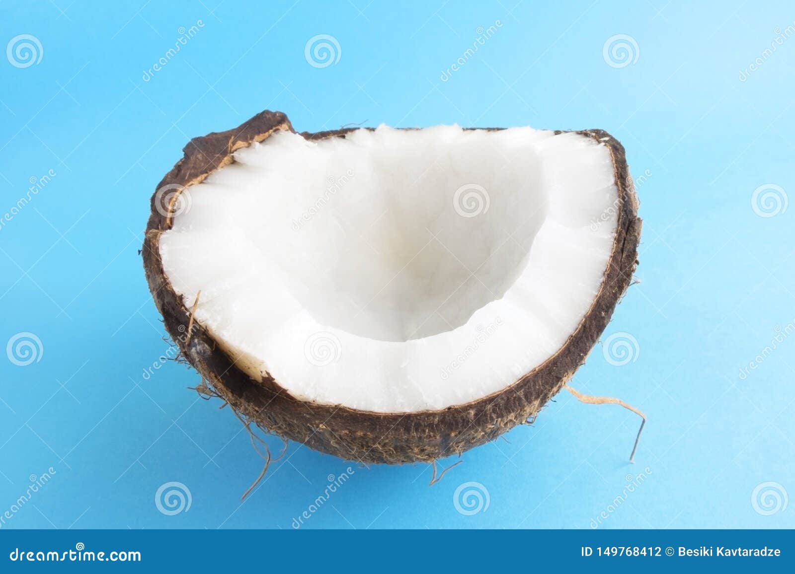 Piece of coconut on blue. stock photo. Image of idea - 149768412