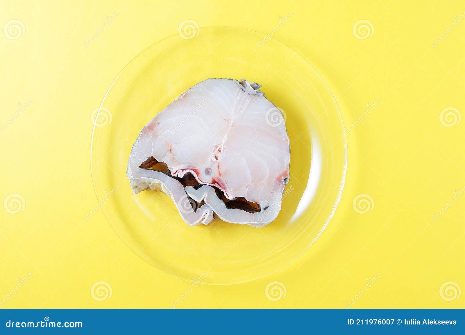 Piece of Cod Fish Steak on Transparent Glass Plate. Yellow Background ...
