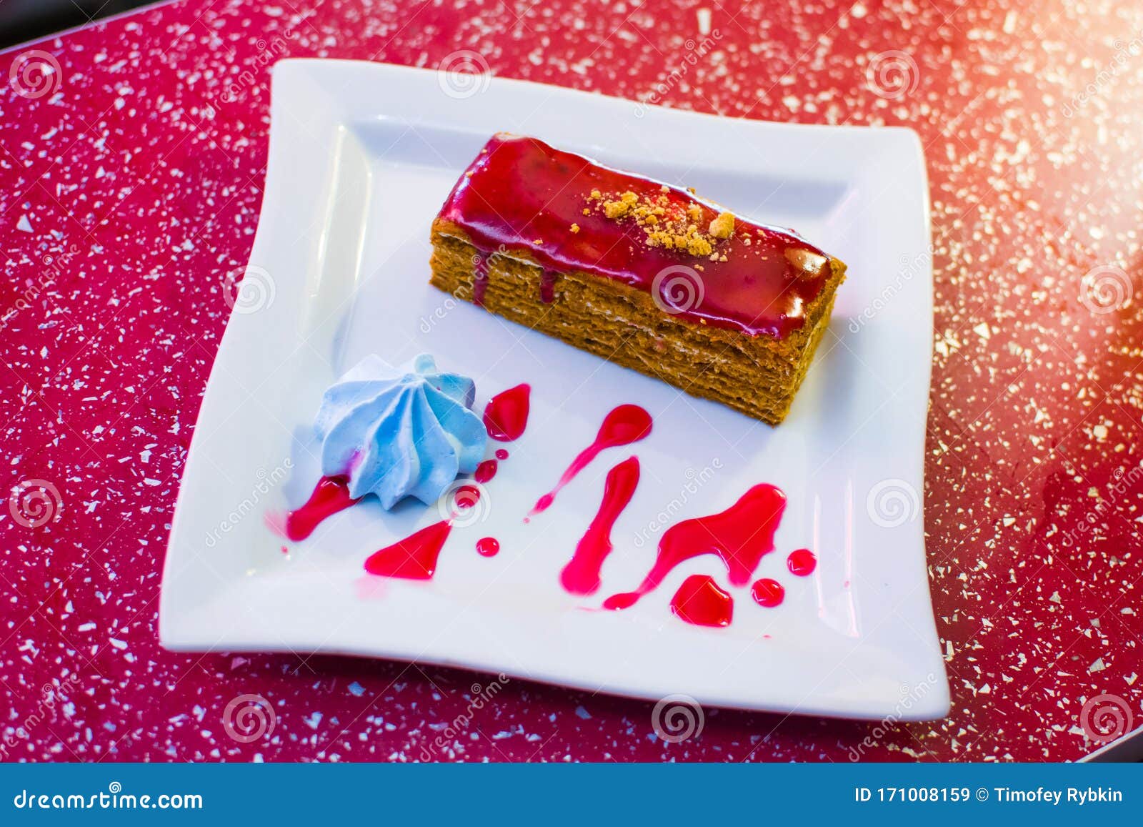 A Piece of Fresh Decorated Cake on a Plate, Poured with Cream Stock ...