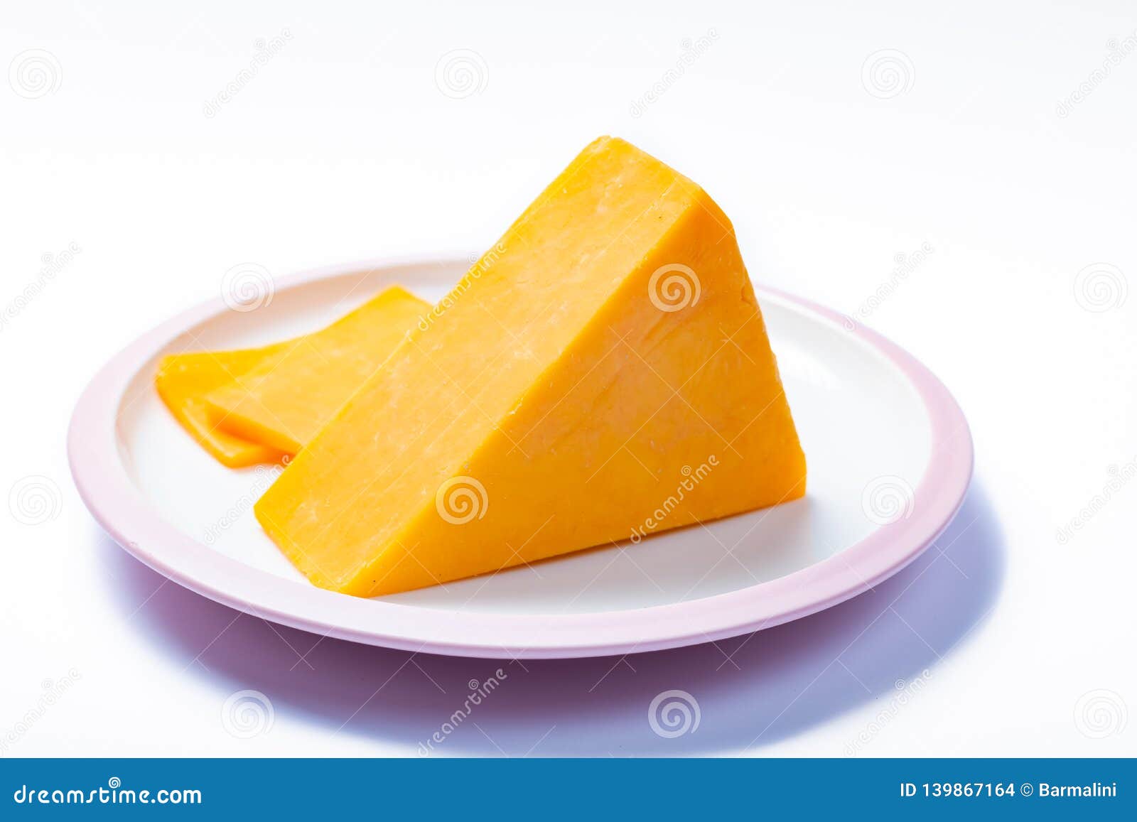 Piece of Hard Orange Cheddar Cheese on White Board Isolated Close Up ...
