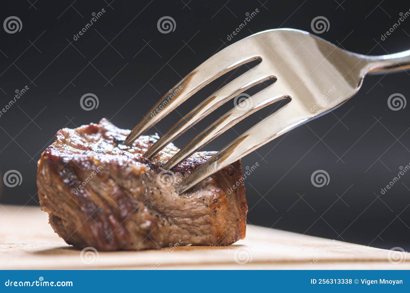 Piece of meat on a fork . stock photo. Image of rare - 256313338