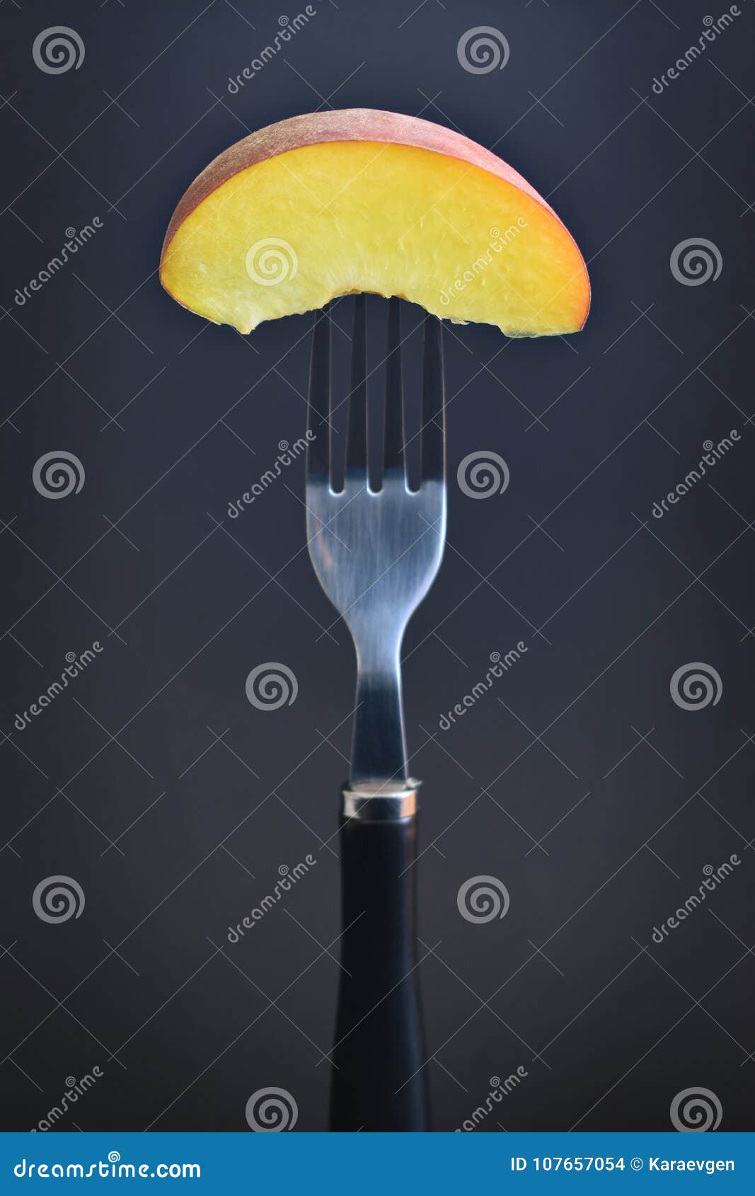Piece of peach on a fork stock photo. Image of leaf - 107657054