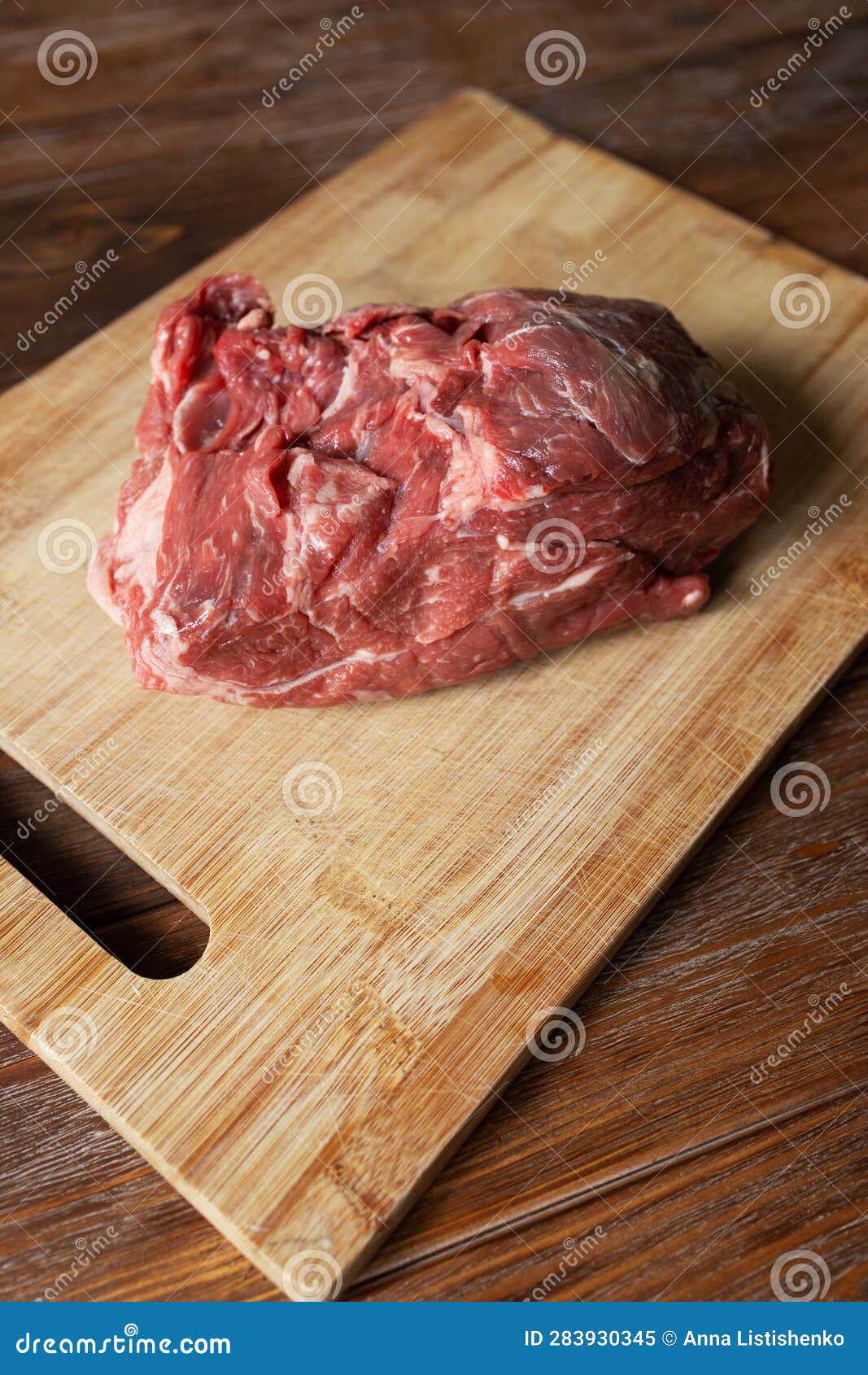 A Large Piece of Beef on Cutting Board. Vertical Photo Stock Image ...