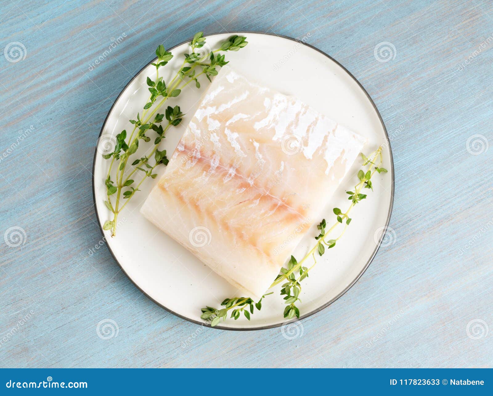 Piece of Raw Cod Fish Fillet on Plate on Blue Wooden Table, Top View ...