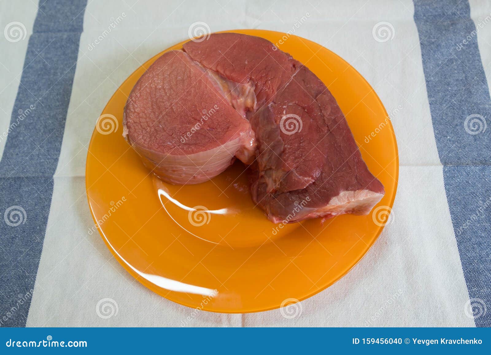 Piece of Raw Meat on an Orange Plate. Stock Photo - Image of blur ...