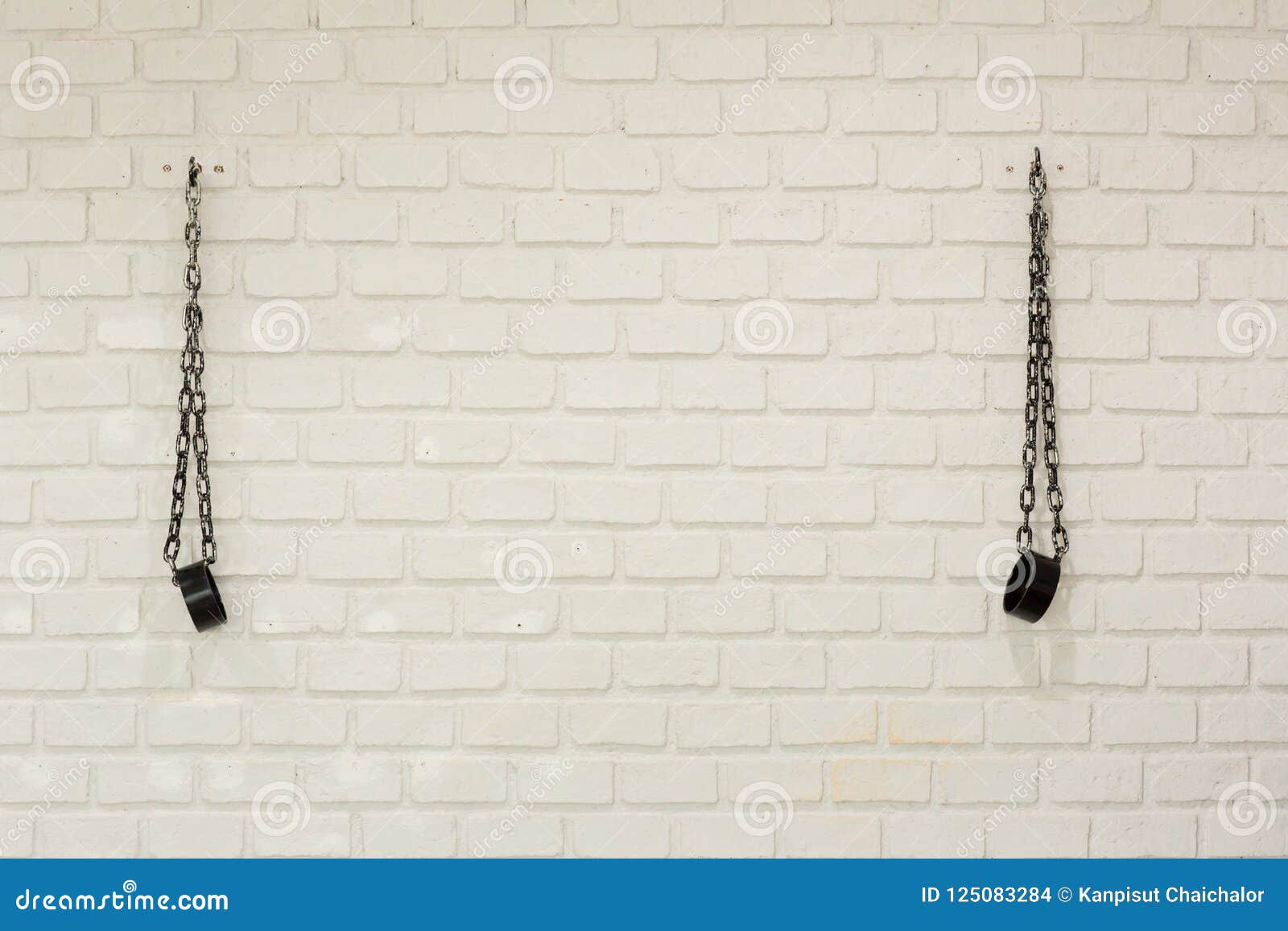 A Piece of Rusty Chain Hangs on a Stone Wall.Slave Handcuffs Holding ...