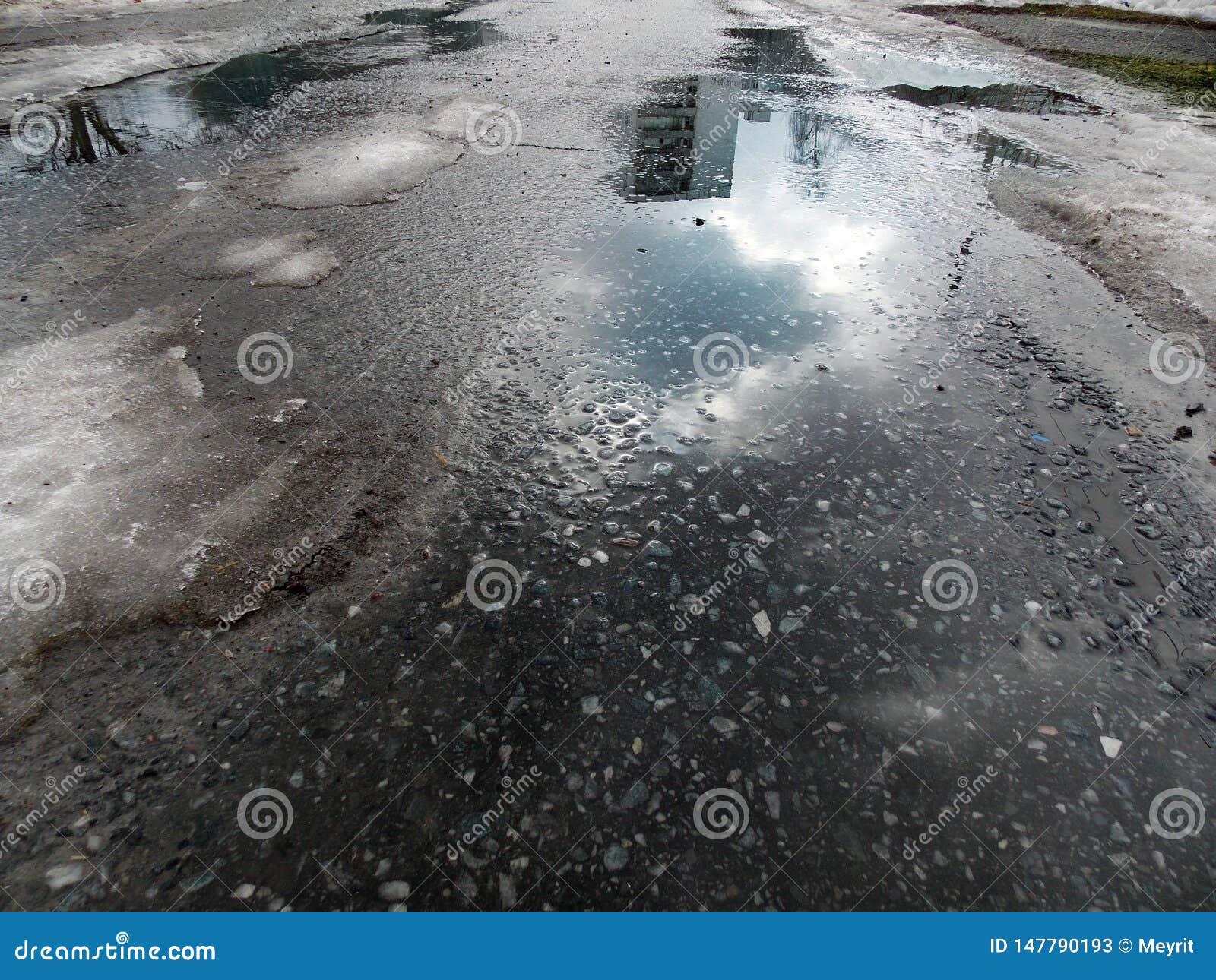 A Piece of Spring Sky, Which is Reflected in the Melted Puddle on the ...