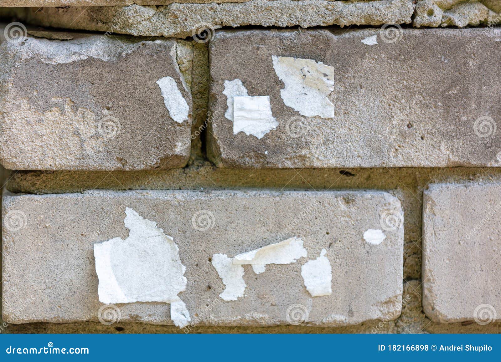 Pieces from Ads on a Brick Wall Stock Photo - Image of brickwork, glued ...