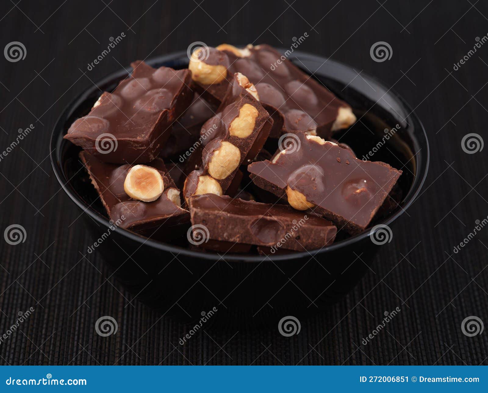 Pieces of Broken Dark Chocolate with Hazelnut in a Black Bowl Stock ...
