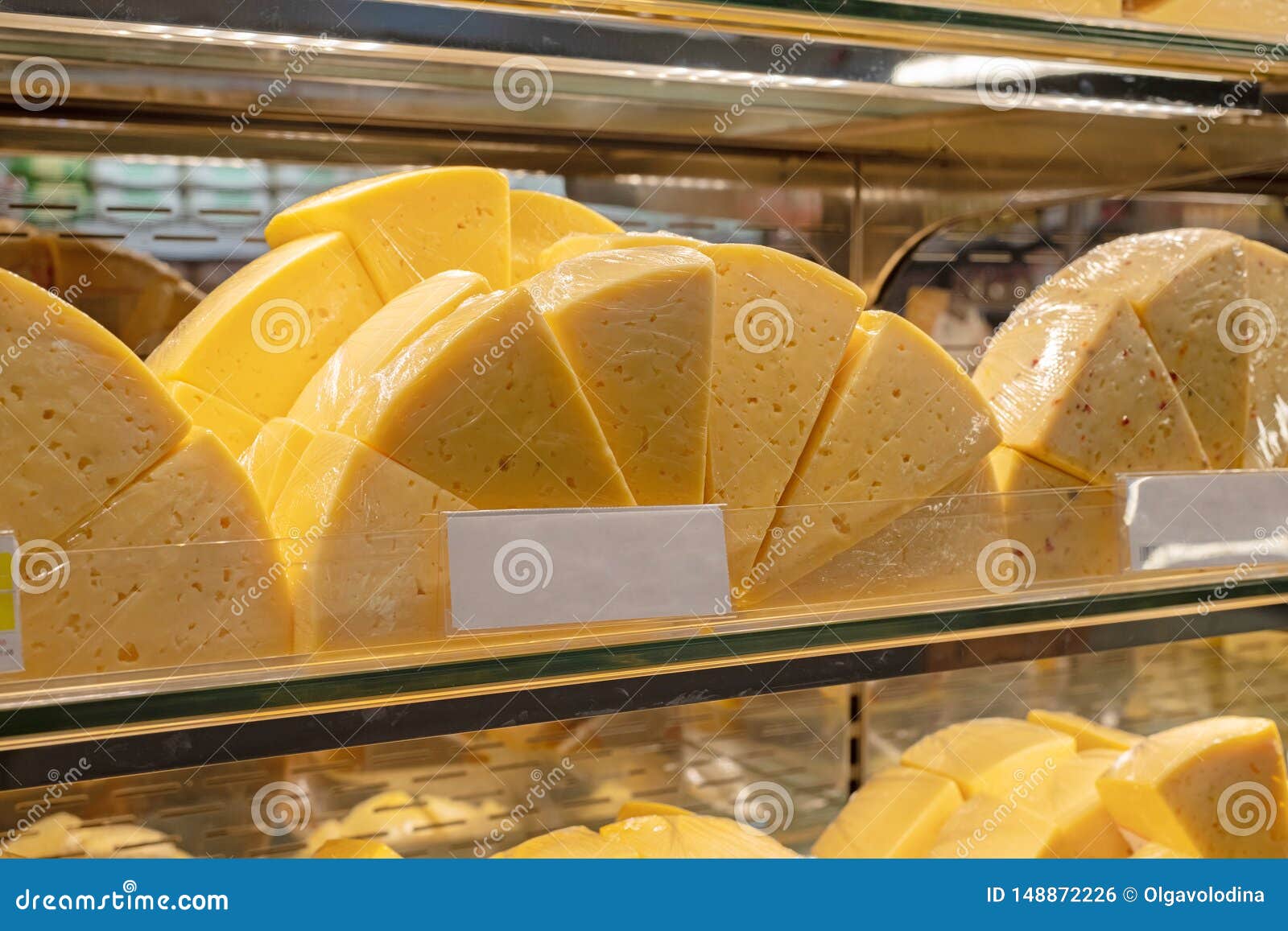 A Pieces of Cheese in the Shop Window Stock Photo - Image of heads ...
