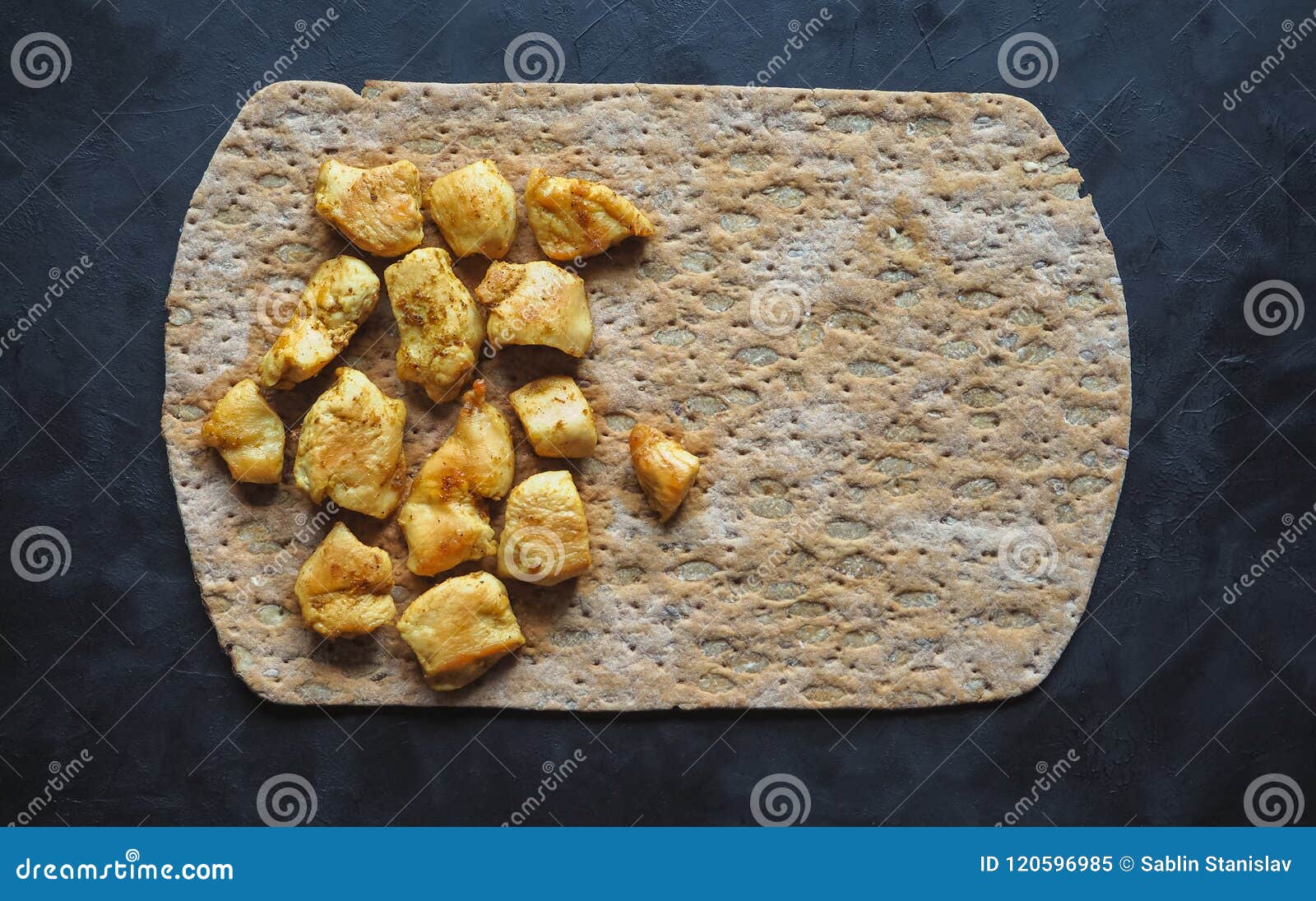 Pieces of Chicken Fillet on Rye Flat Cake with Copy Space. Stock Image ...