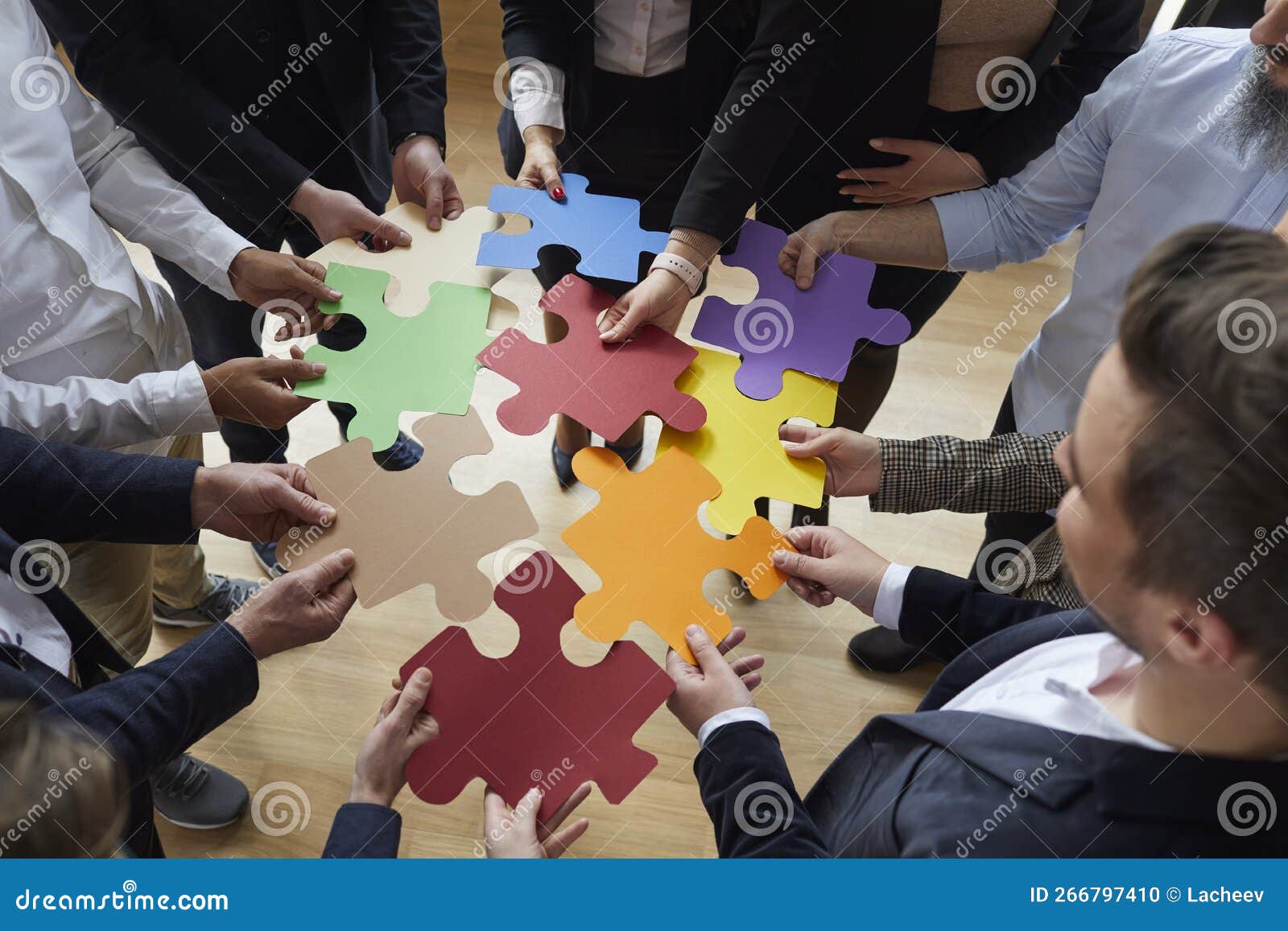 Pieces of Colored Puzzles in Hands of People Standing in Circle and ...