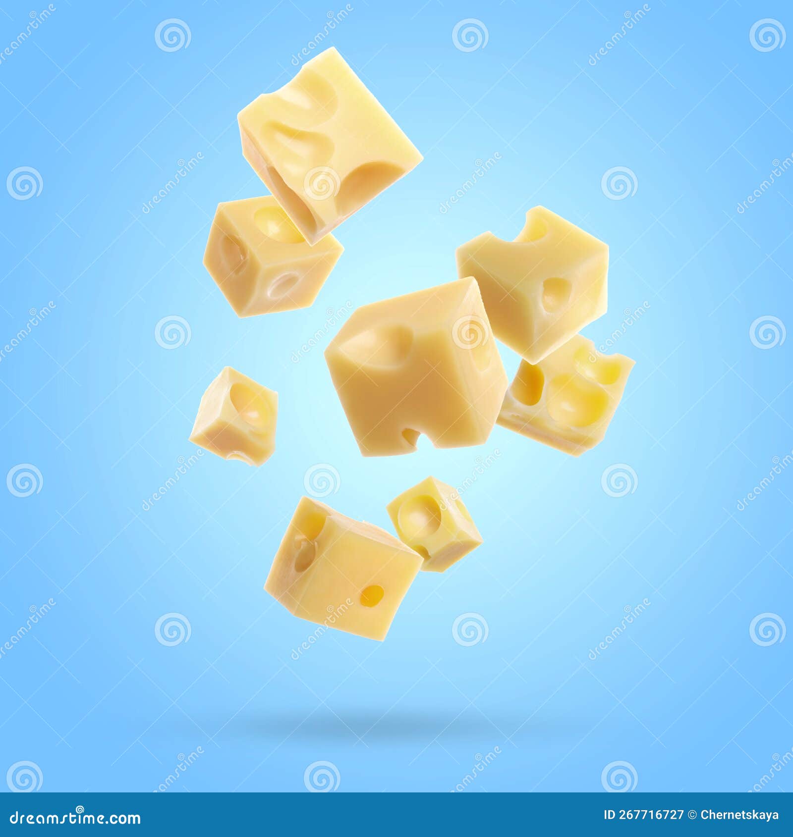 Pieces of Delicious Cheese Falling on Light Blue Background Stock Image ...