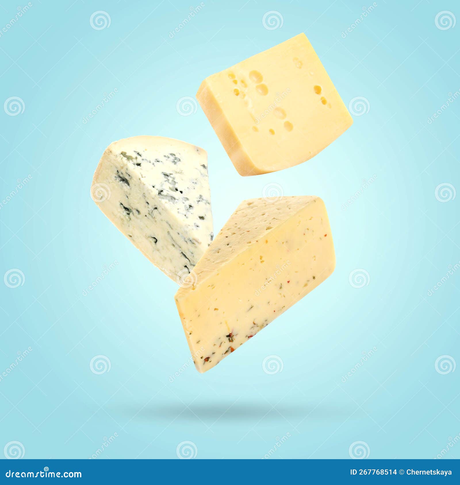 Pieces of Different Delicious Cheese Falling on Light Blue Background ...