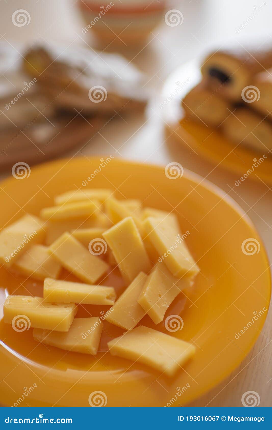 Pieces of Hard Cheese Lie on a Plate on the Kitchen Table Stock Image ...