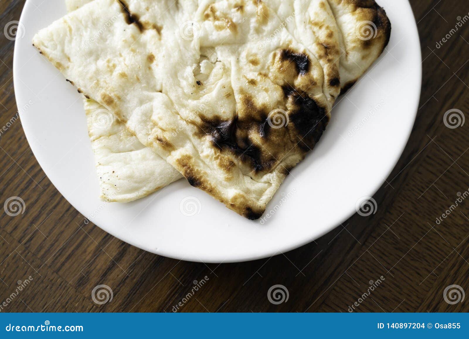 Pieces of Indian Nann Bread on White Plate Stock Photo - Image of ...