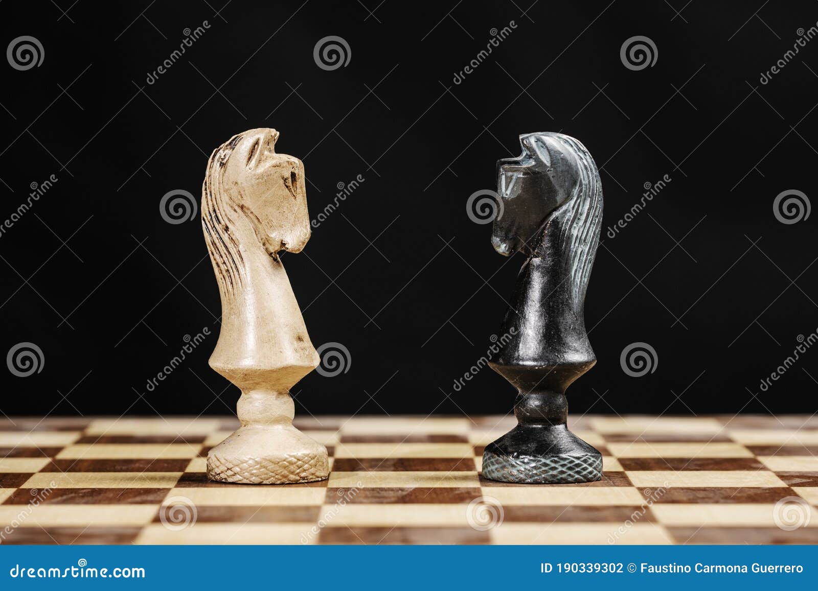 Pieces of Knights Facing Each Other on a Chessboard Against a Black ...
