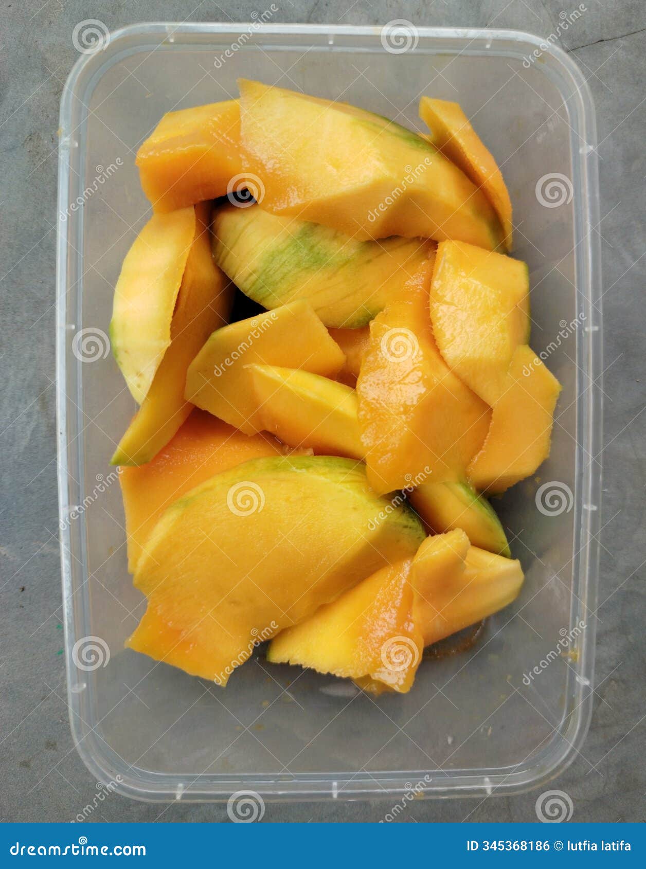Pieces of Mango Fruit in a Mica Container on a Gray Background Stock ...