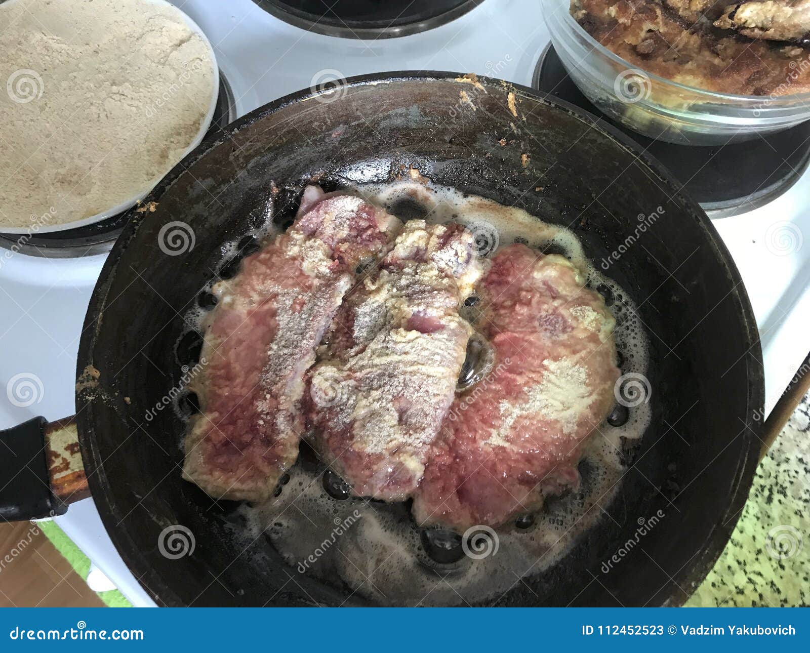 Pieces of Meat are Fried in a Hot Frying Pan. There are Splashes of Hot ...