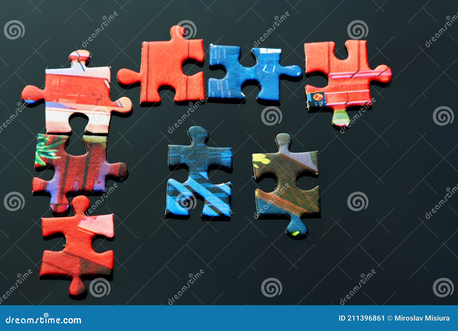 Pieces of the Puzzle are Scattered on the Table in Different Directions ...