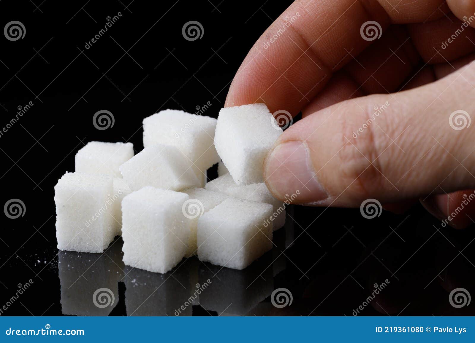 Pieces of Sugar in Hand on a Black Background Stock Photo - Image of ...