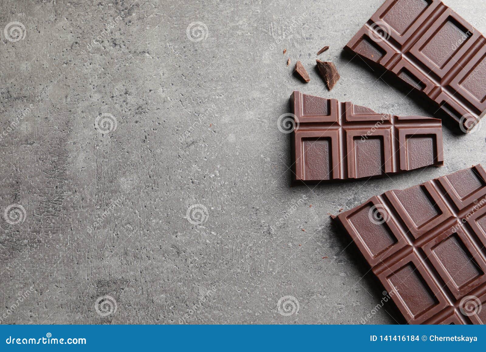 Pieces of Tasty Chocolate on Grey Background, Flat Lay. Stock Photo ...