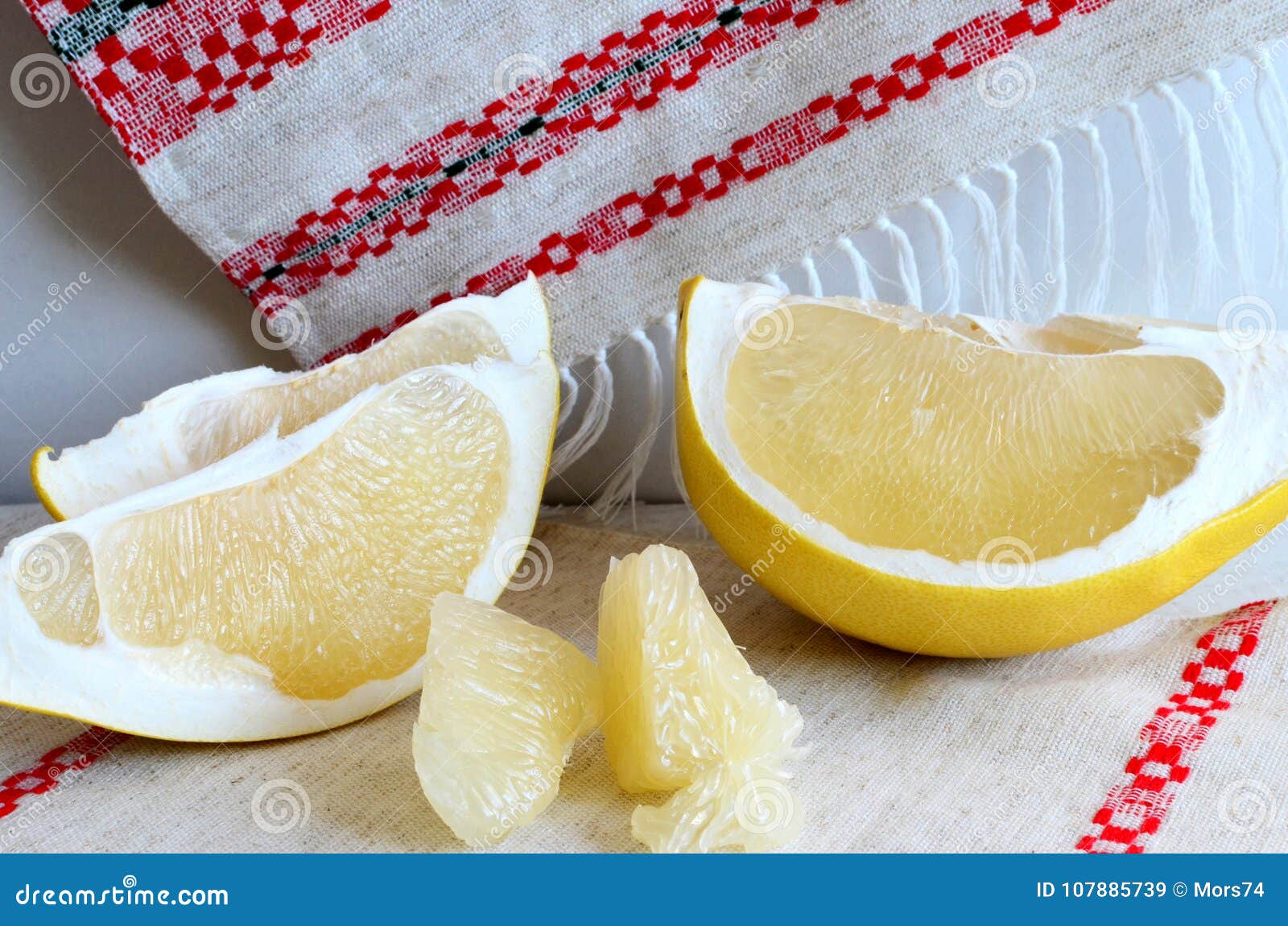 Pamela Fruit, Cut into Pieces, on a White Background Stock Image ...