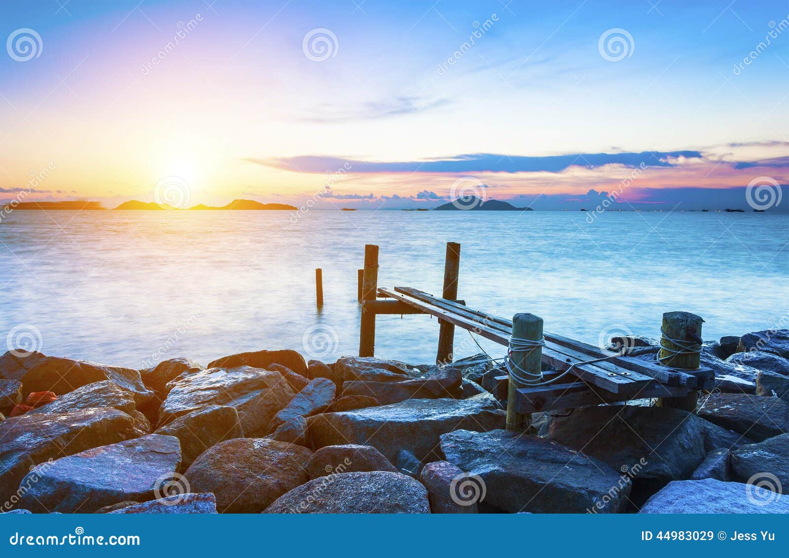 Pier over sunset waters stock image. Image of relax, chair - 44983029