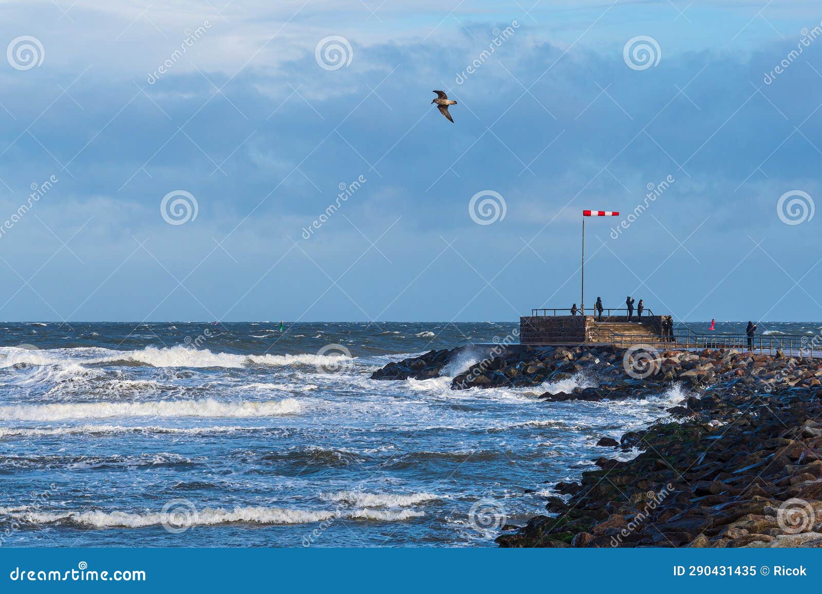 Pier and Windsock on Shore of the Baltic Sea in Warnemuende, Germany ...