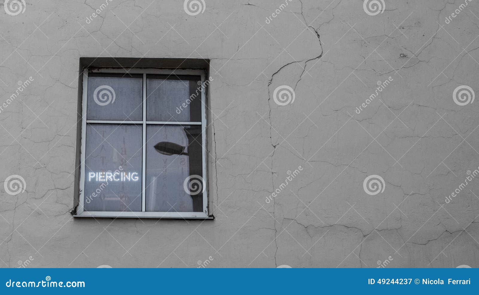 Piercing White Light Sign on a Window in an Old Building Stock Image ...