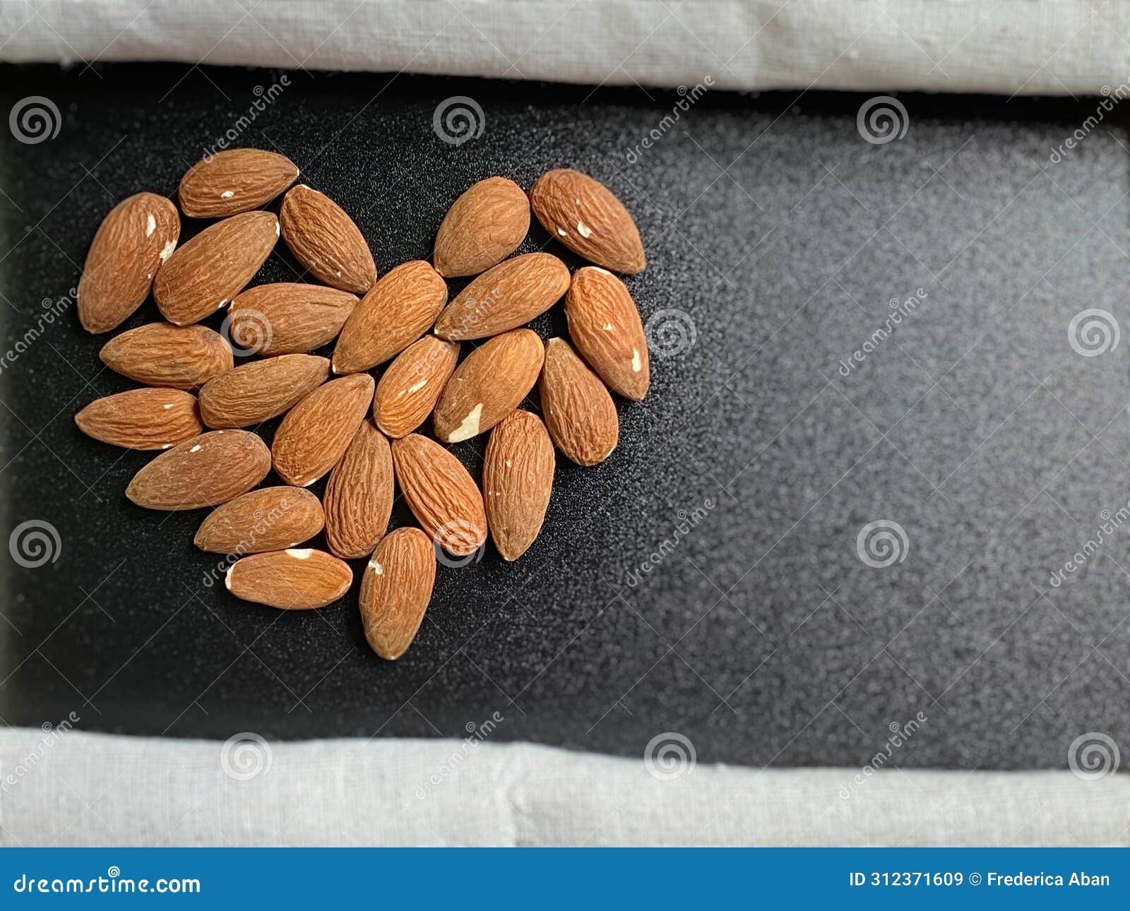 A Pile of Almonds in Heart Shape Background. Healthy Eating Concept ...