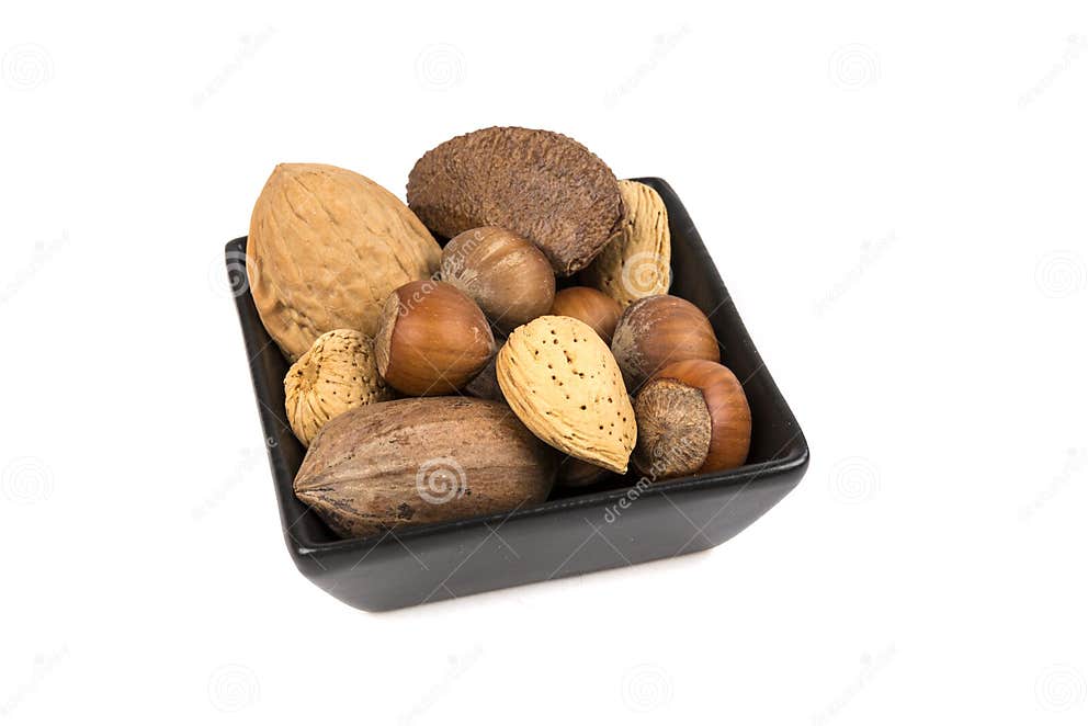 Pile of Assorted Nuts in the Shell in a Black Bowl Isolated Over White ...