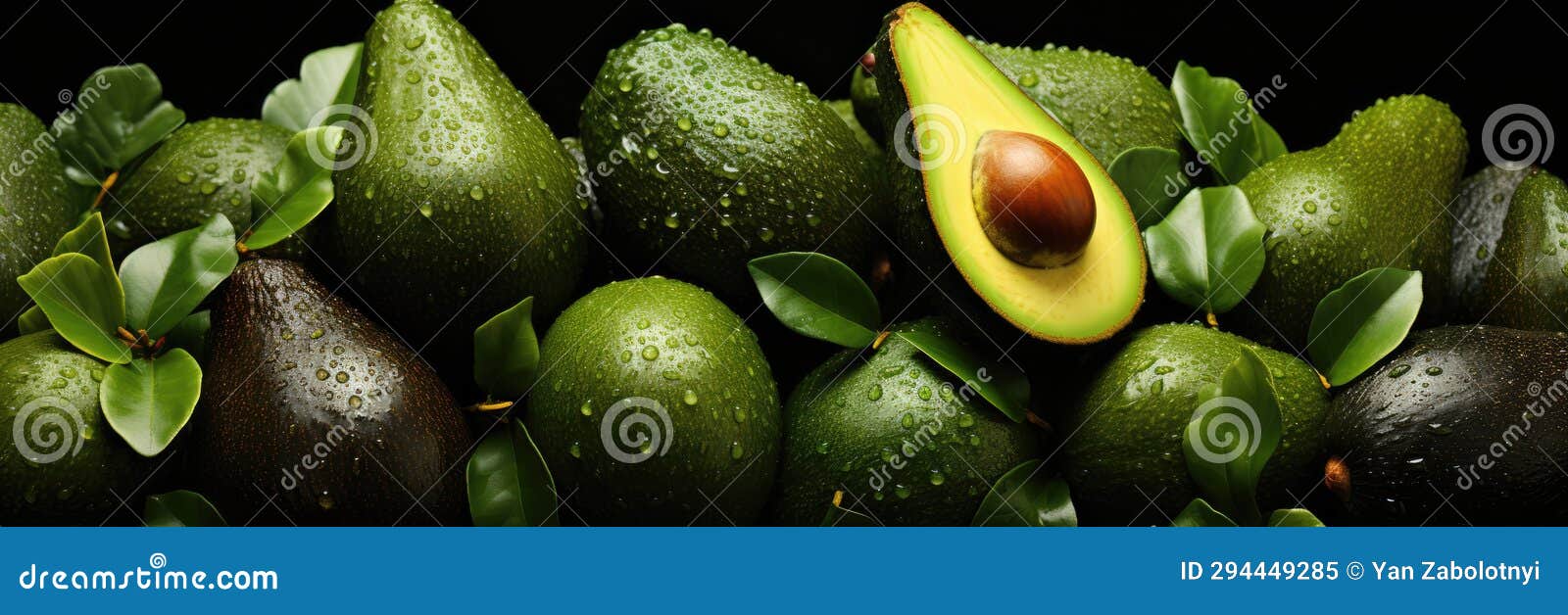 A Pile of Avocados with Leaves and an Avocado Cut in Half Stock ...
