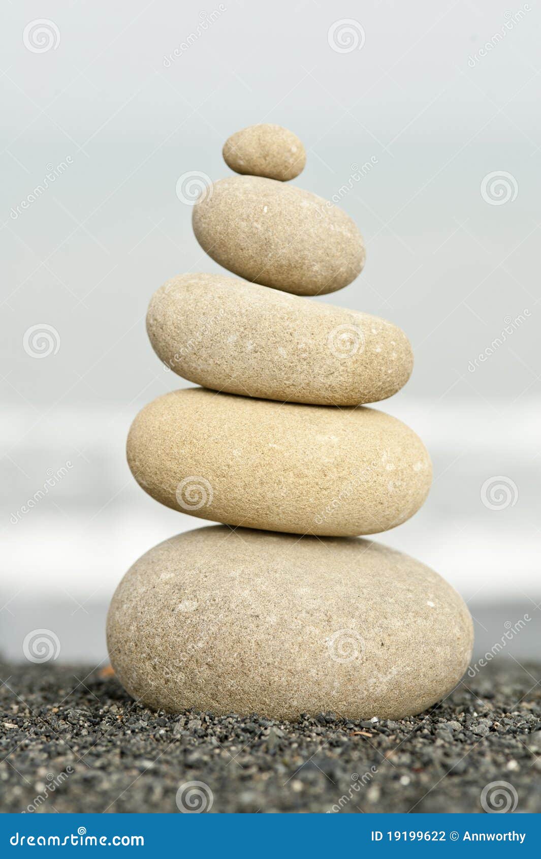 Pile of Balanced Rocks on Black Sandy Beach Stock Photo - Image of ...