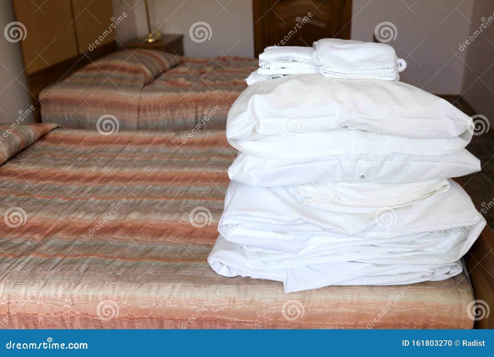 Pile of bedding on bed stock photo. Image of fluffy - 161803270