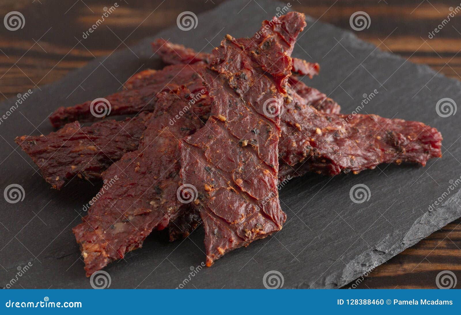 Pile of Black Pepper Beef Jerky on a Rustic Wooden Table Stock Photo ...