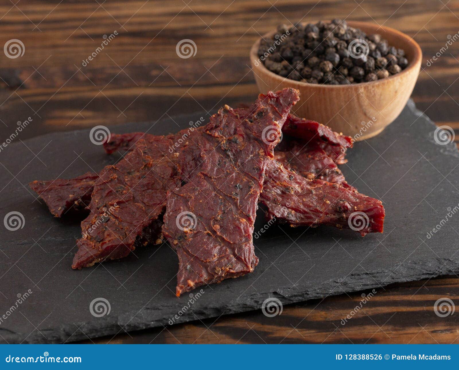 Pile of Black Pepper Beef Jerky on a Rustic Wooden Table Stock Photo ...