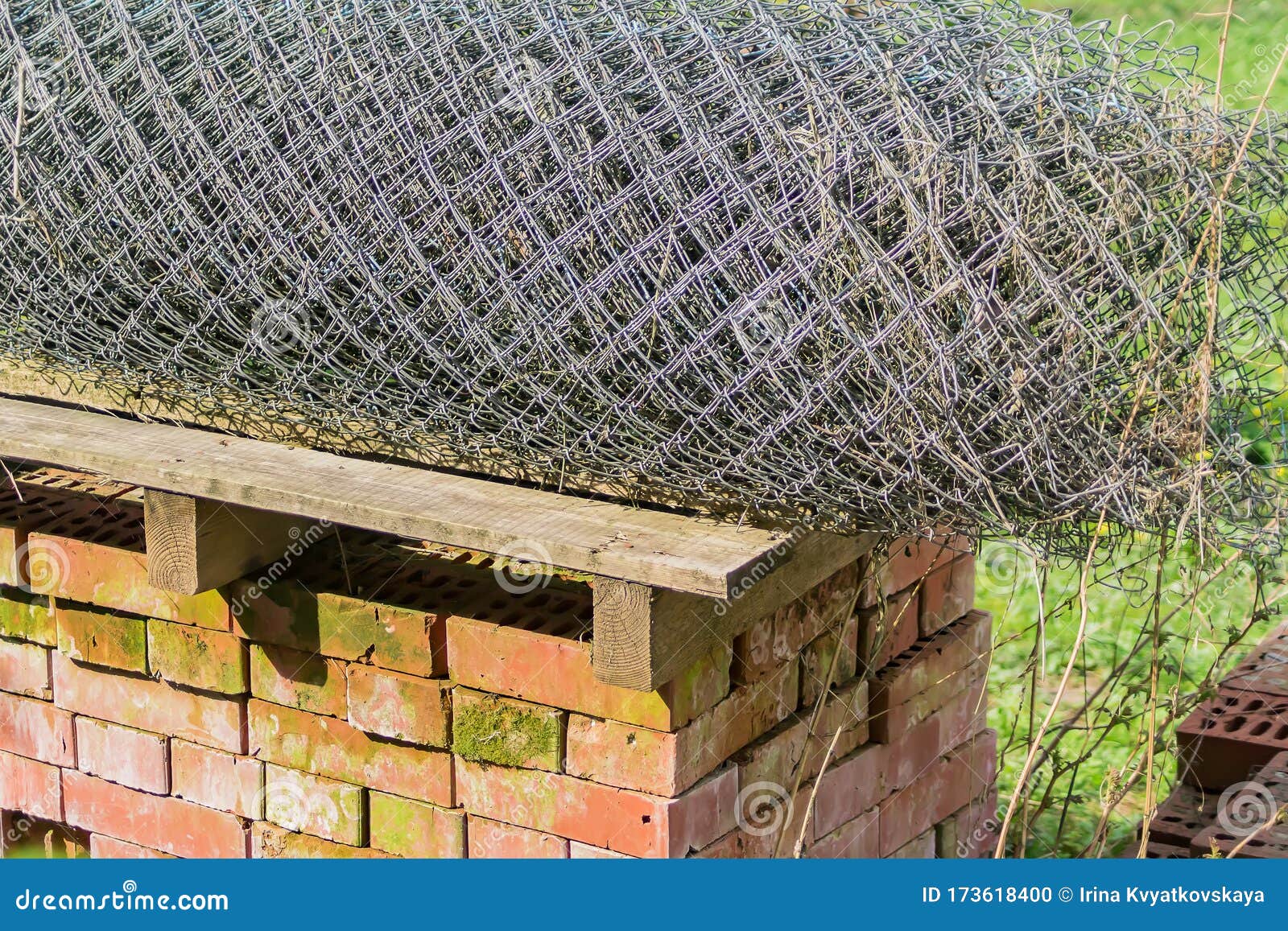 Pile of Bricks and Rolls of Wire Mesh Steel for Construction Outdoors ...