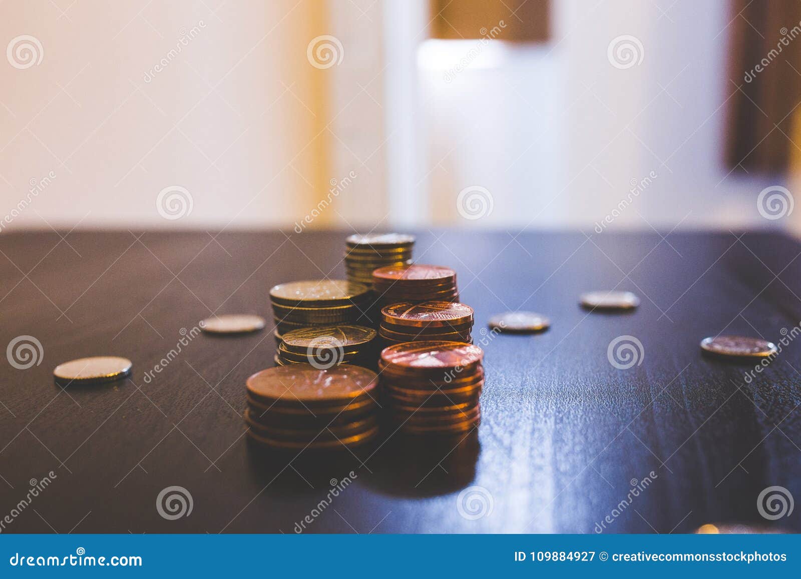 Pile Of Brown Coins On Brown Wooden Table Top Picture. Image: 109884927