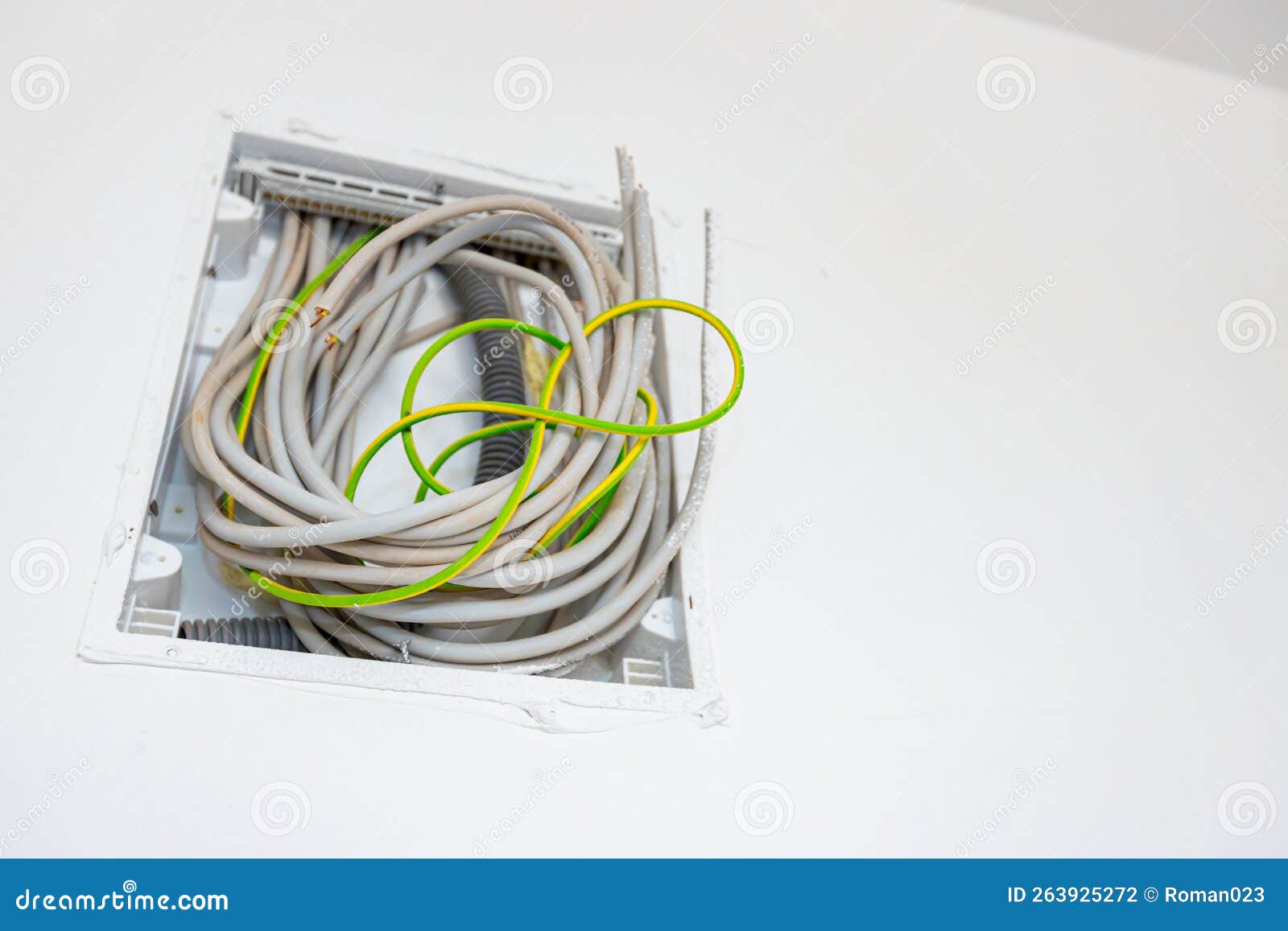 Pile of Cables is Hanging from a Fuse Box Placed on the Wall of ...