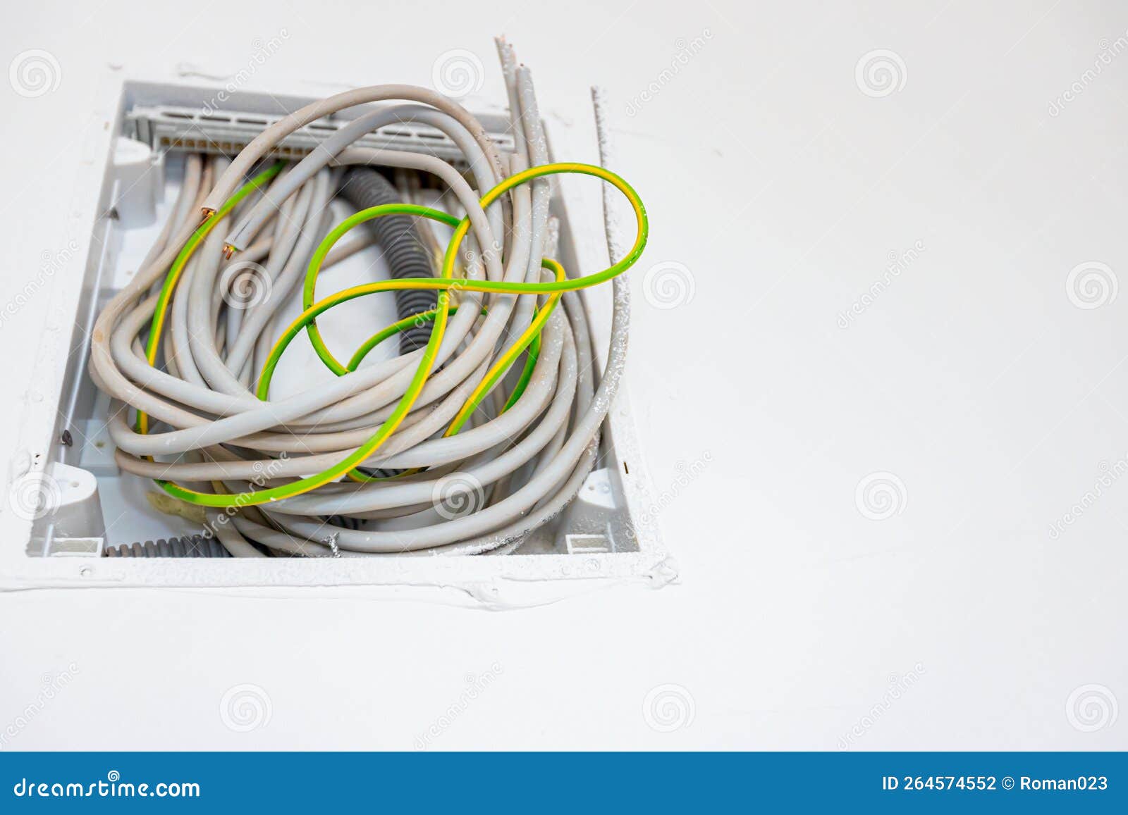 Pile of Cables is Hanging from a Fuse Box Placed on the Wall of ...