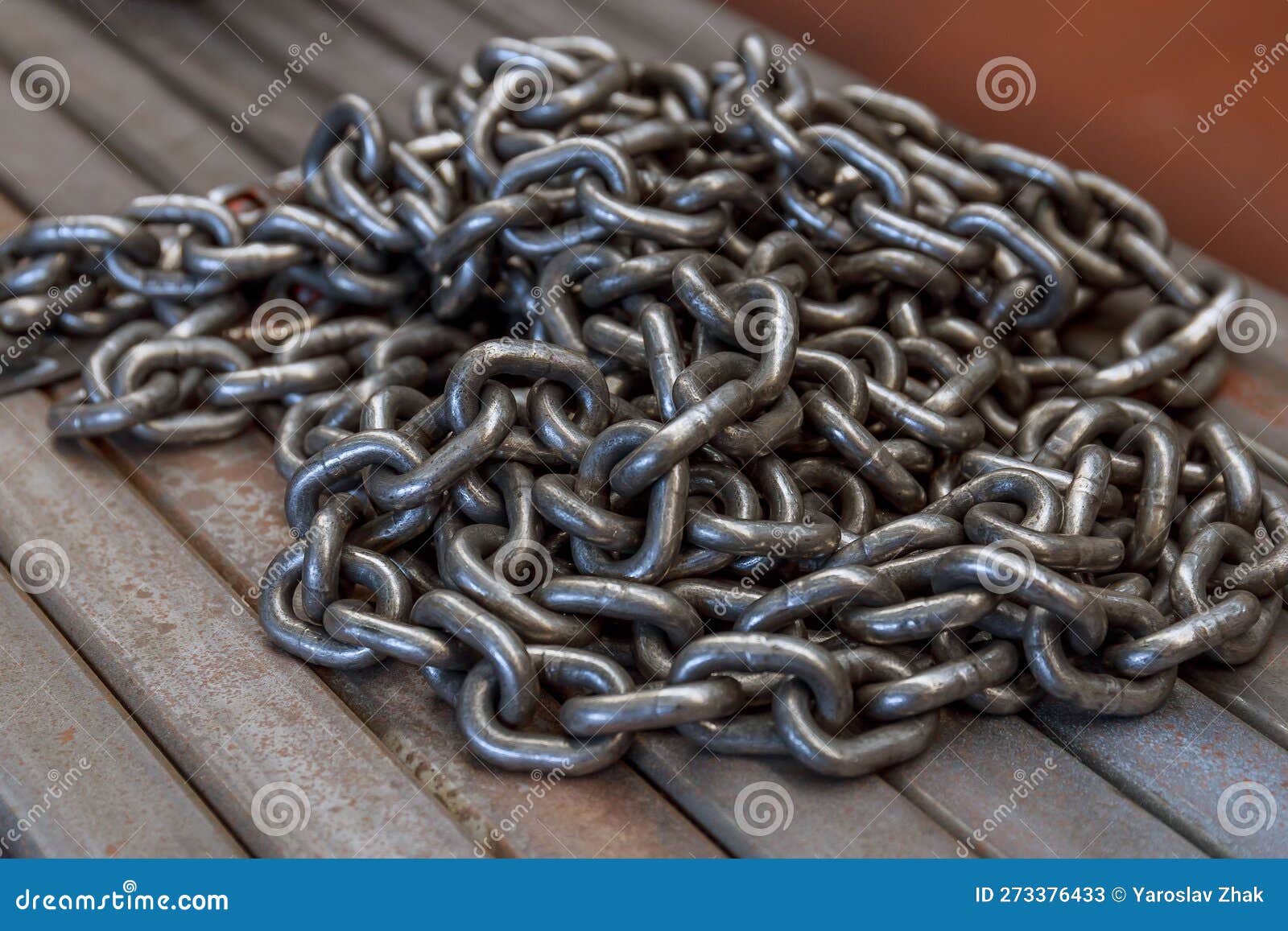 A Pile of Chain Rests on a Bundle of Rolled Metal Pipe. Stock Image ...