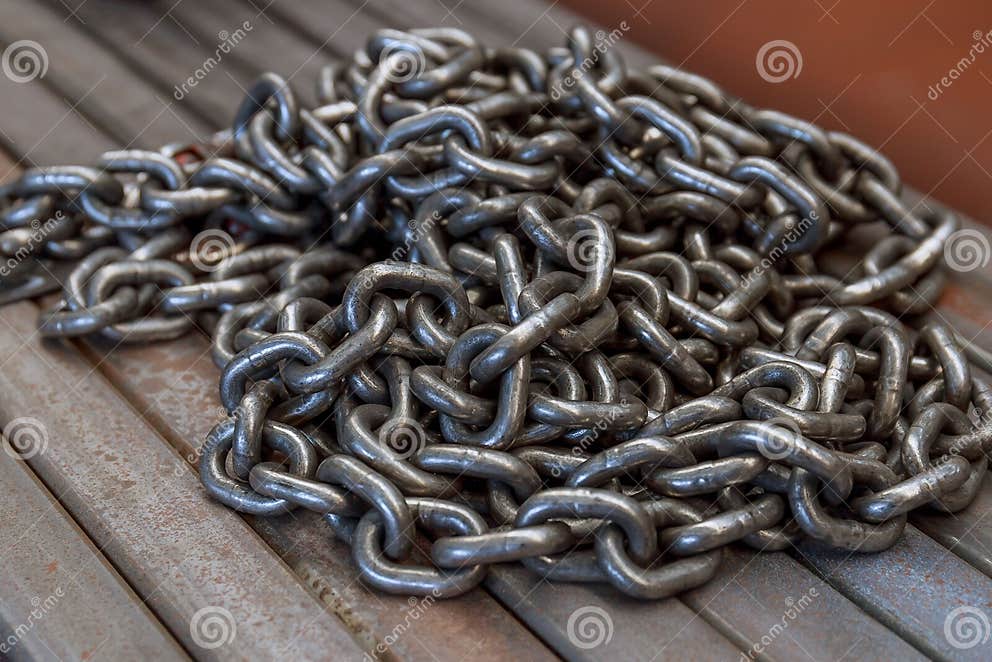 A Pile of Chain Rests on a Bundle of Rolled Metal Pipe. Stock Image ...