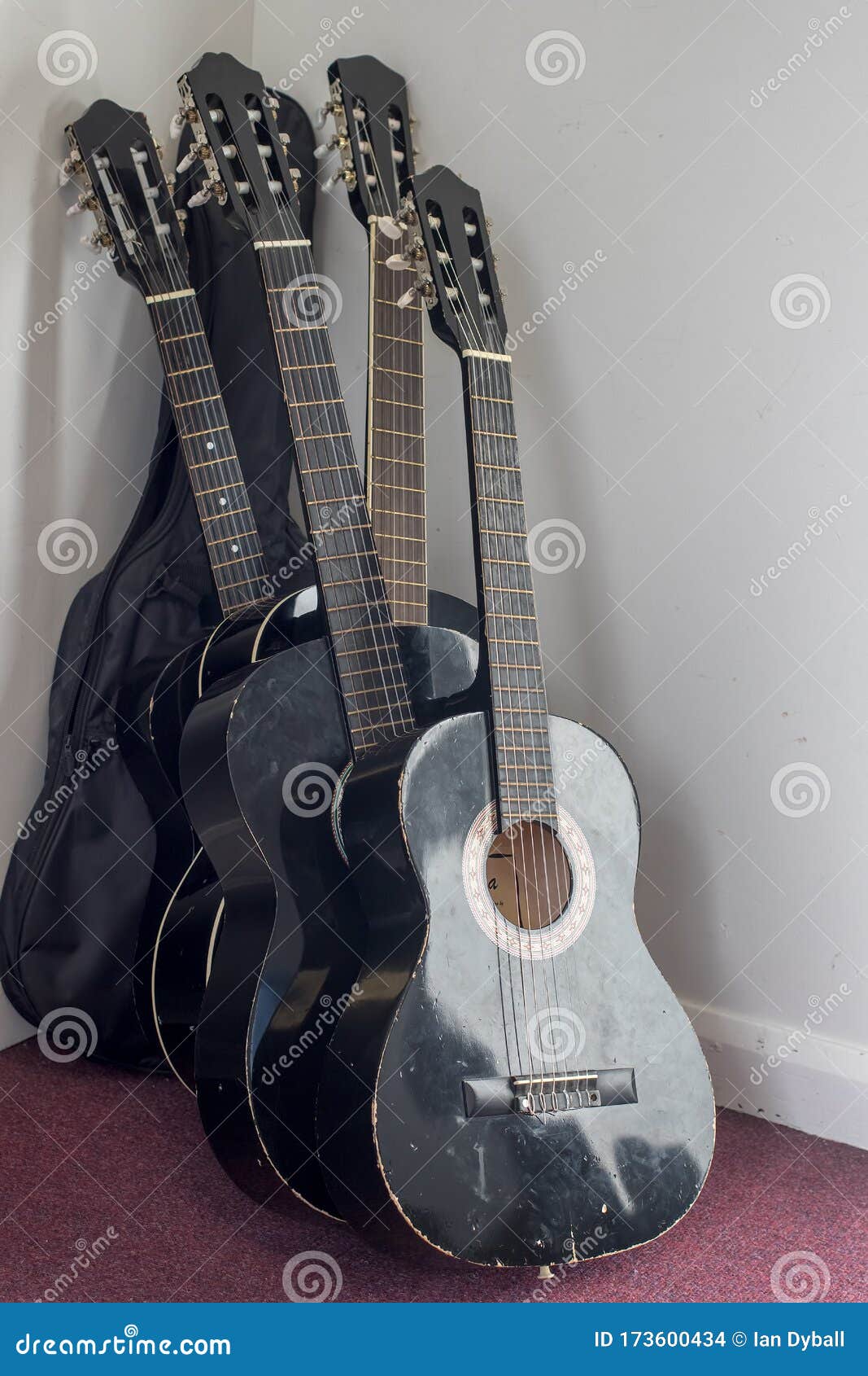 Pile of Cheap Black Classical Acoustic Guitars on Music Room Floor ...