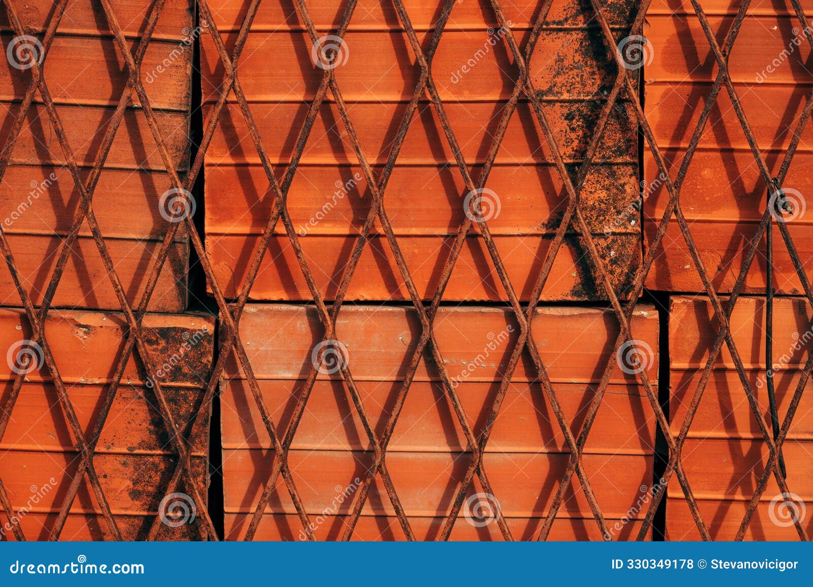 Pile of Clay Construction Blocks Behind Worn Rusty Fence Stock Photo ...