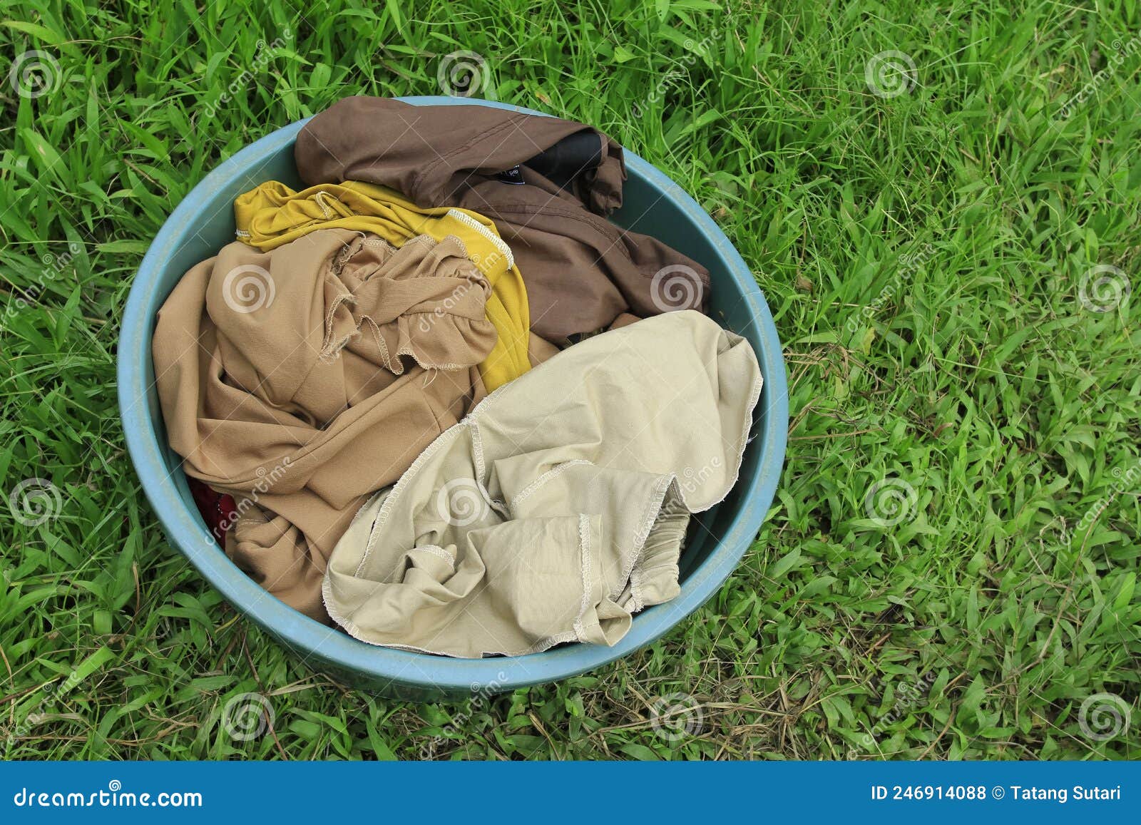 Pile of Clothes in the Basin on the Grass. Stock Photo - Image of play ...