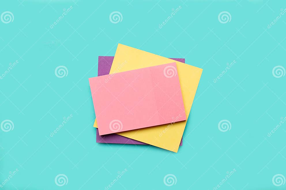 A Pile of Colored Paper Notes on a Light Blue Background Stock Image ...