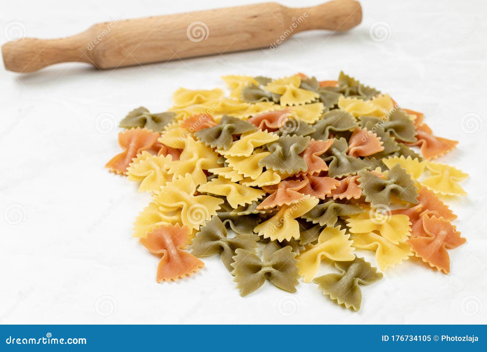 Pile of Colored Pasta in Bow Shape with Wooden Rolling Pin Stock Image ...