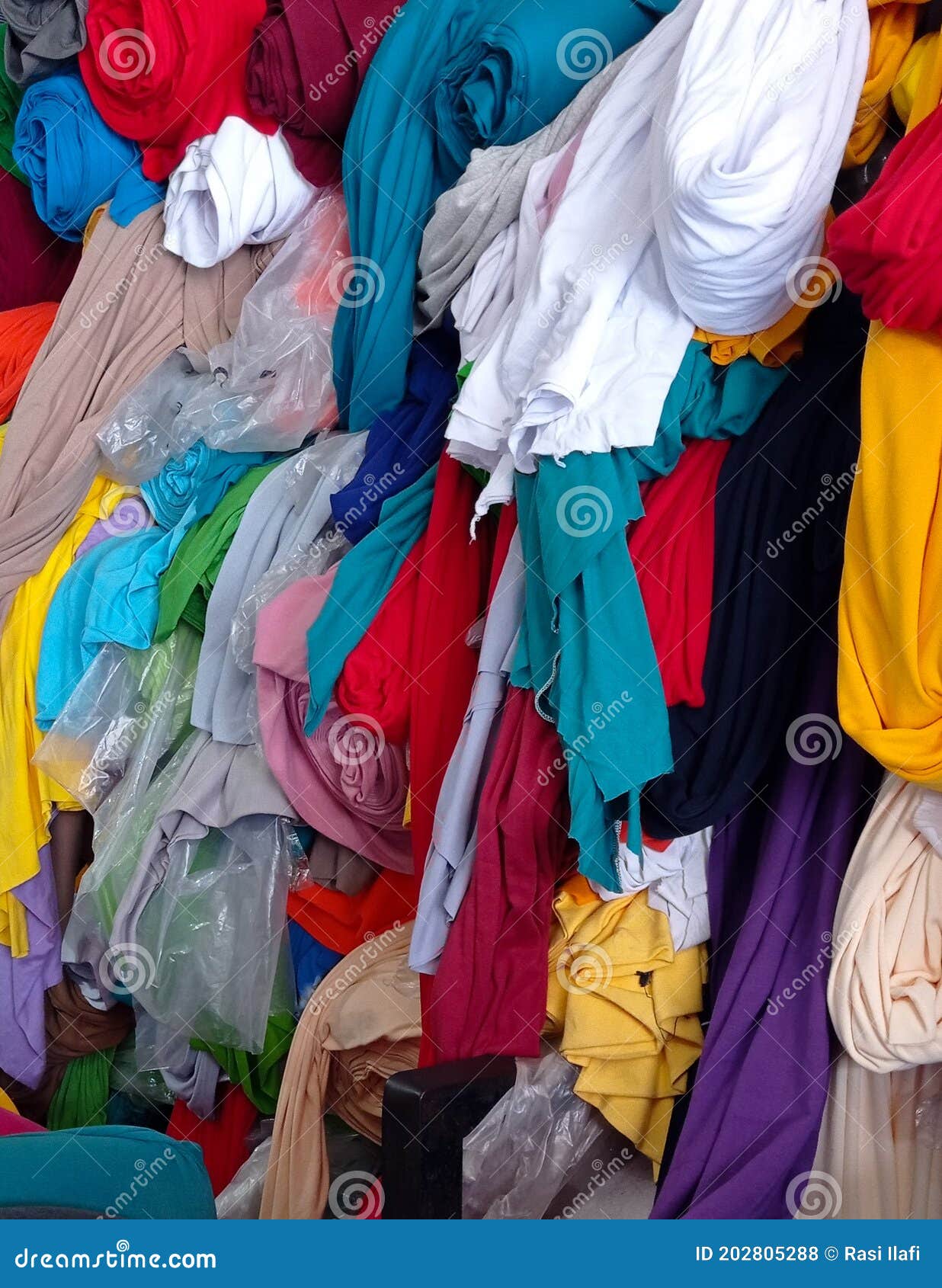 A pile of colorful fabrics stock photo. Image of market - 202805288