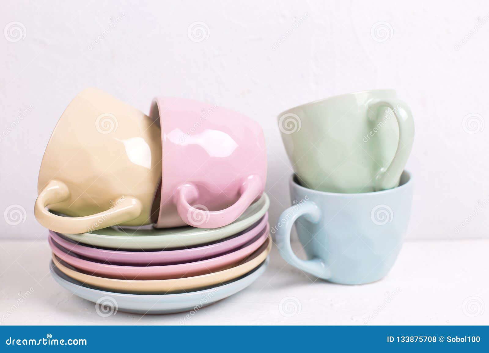 Pile of Colourful Tea Cups and Saucers on White Textured Background ...